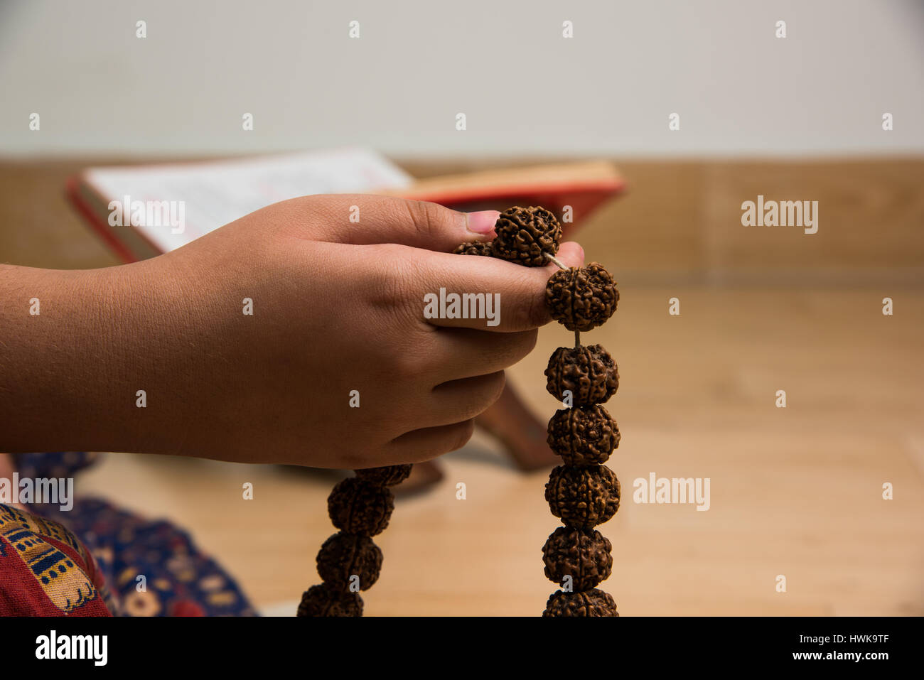closeup picture of hand while doing Meditation with rudraksha mala or ...