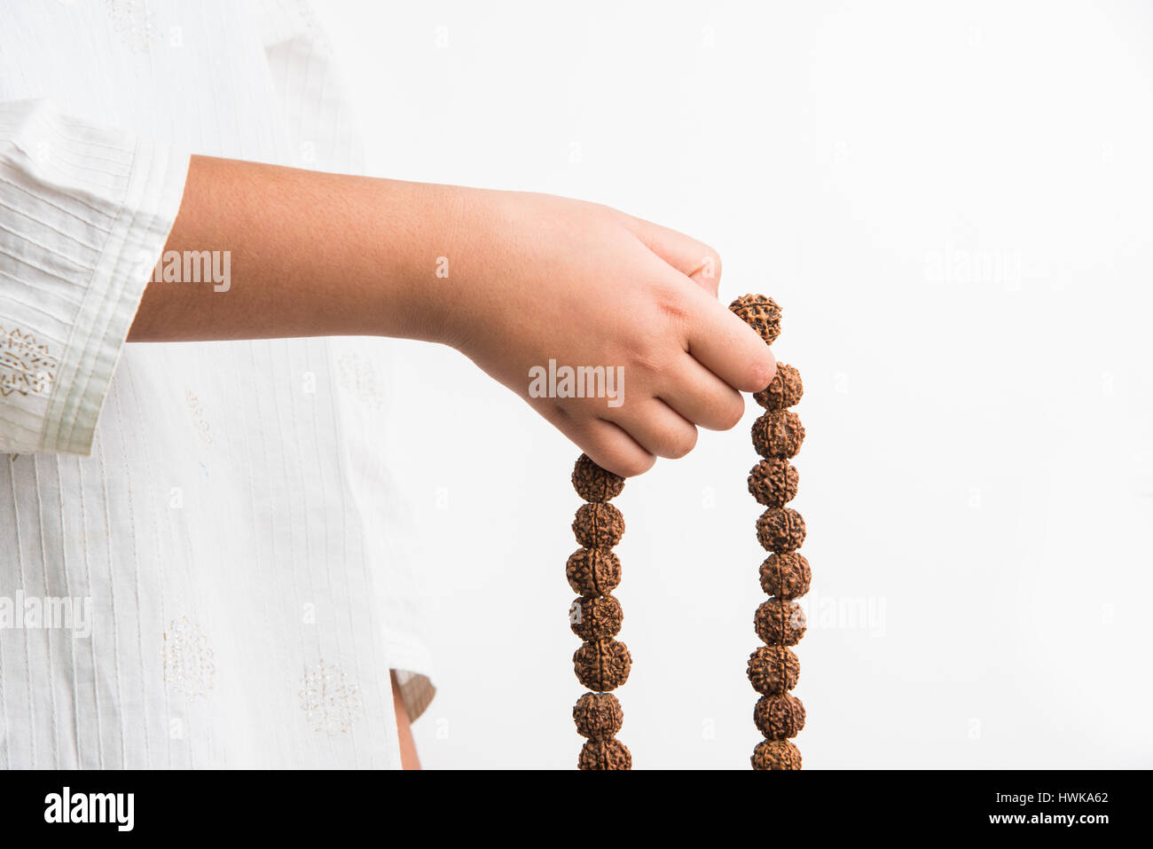 closeup picture of hand while doing Meditation with rudraksha mala or ...