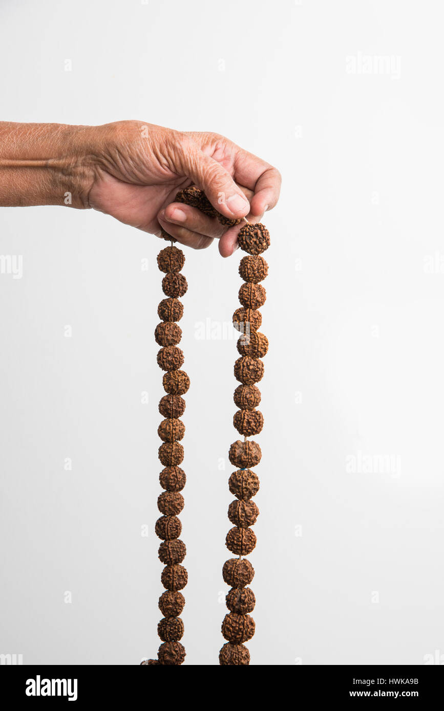 closeup picture of hand while doing Meditation with rudraksha mala or ...