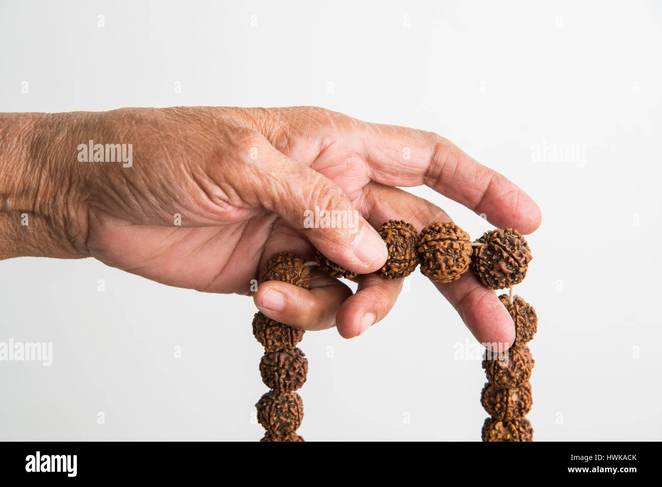 closeup picture of hand while doing Meditation with rudraksha mala or ...