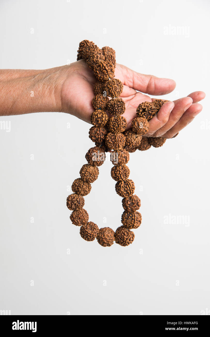 closeup picture of hand while doing Meditation with rudraksha mala or ...