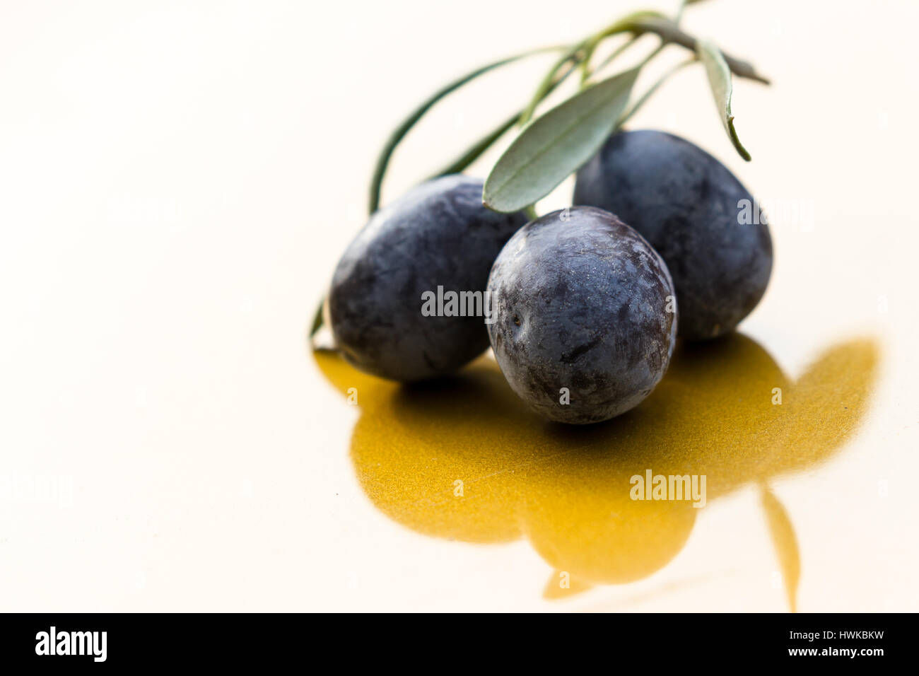 close up of a group of black olives on a golden background Stock Photo ...
