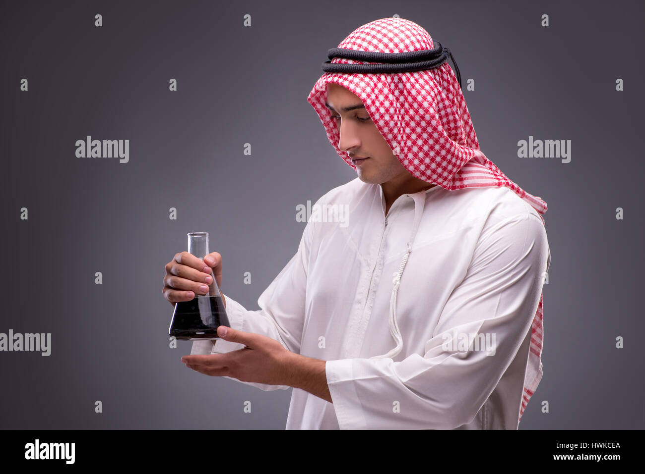 Arab with oil on gray background Stock Photo - Alamy