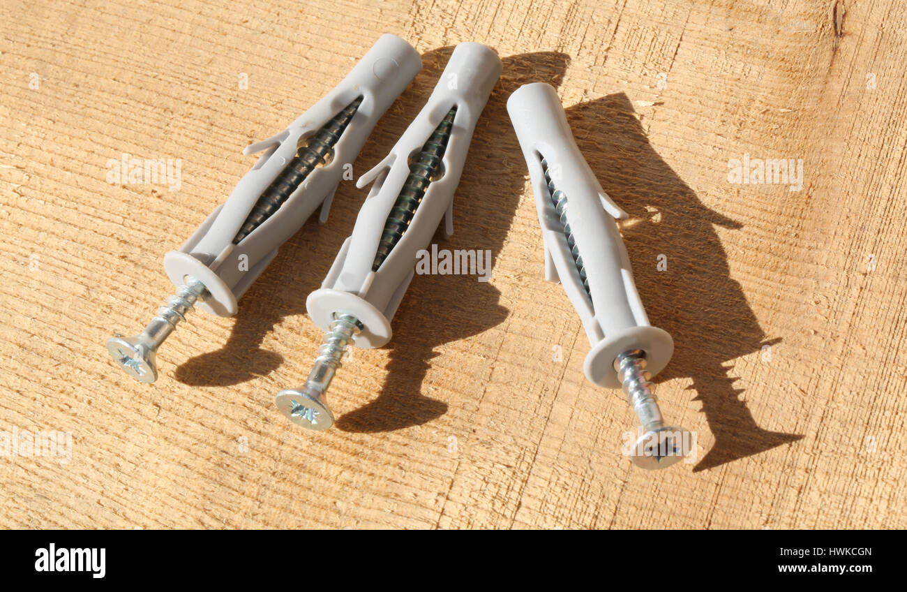 three anchors to secure the materials on the wall and rough wooden ...