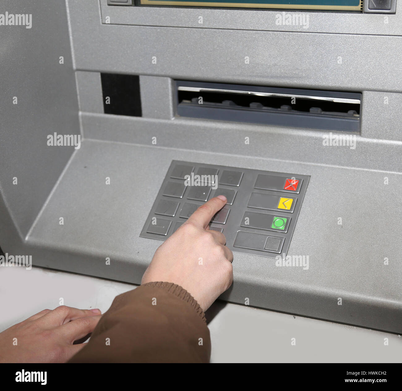 hand typing a PIN into the keypad of an ATM to withdraw money Stock ...