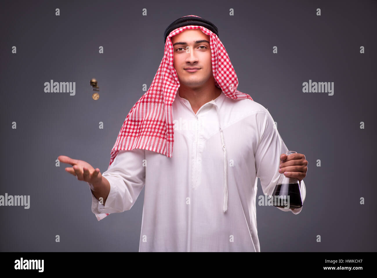 Arab with oil on gray background Stock Photo - Alamy