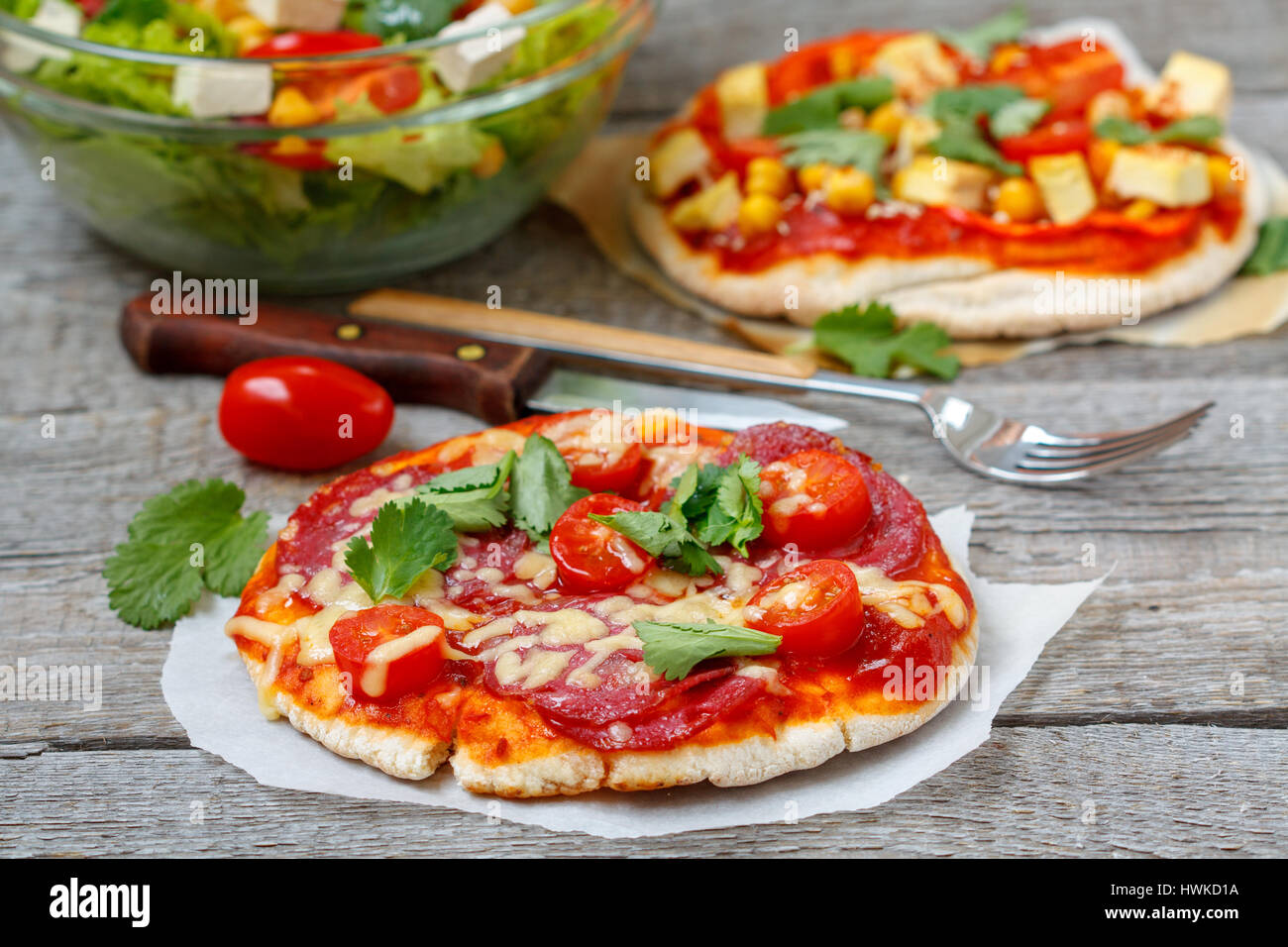 Homemade mini pizzas (meat and vegan) with vegetable salad Stock Photo ...