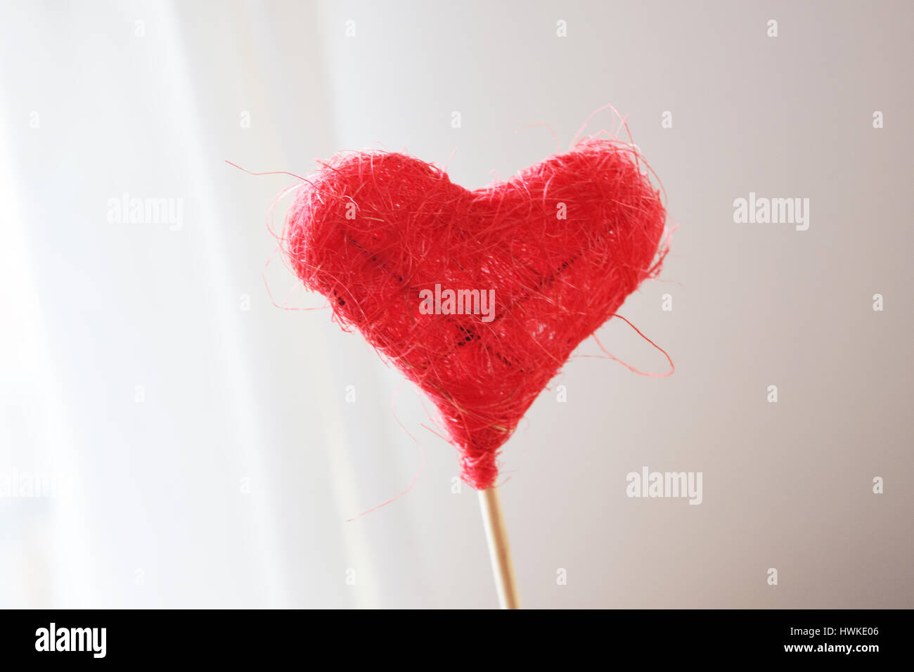 Red Heart on the stick made from thread on white background Stock Photo ...