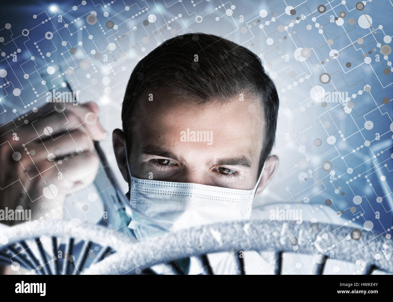 Young scientist mixing reagents in glass flask in clinical laboratory ...