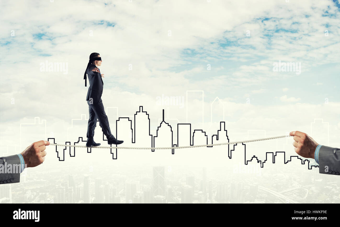 Business concept of risk support and assistance with man balancing on ...