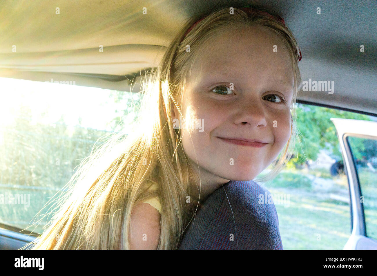 Happy girl in a car with a great smile. Polish girl age 8 smiling in ...