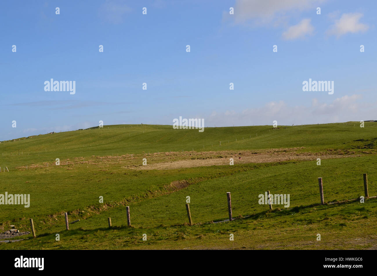 Green rolling hills and fields along the Cliff's of Moher in Ireland ...