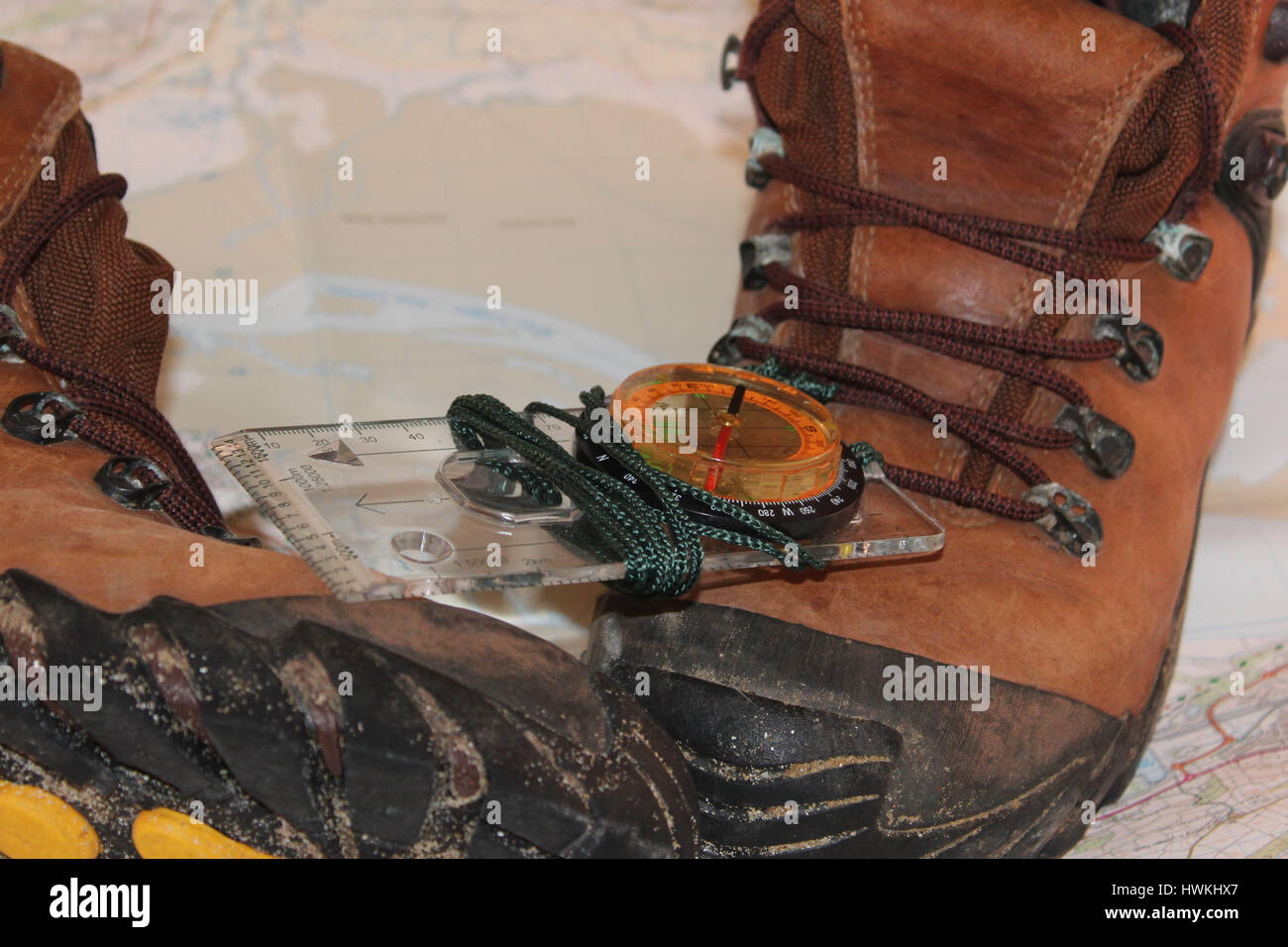 Hiking boots with compass and map Stock Photo - Alamy