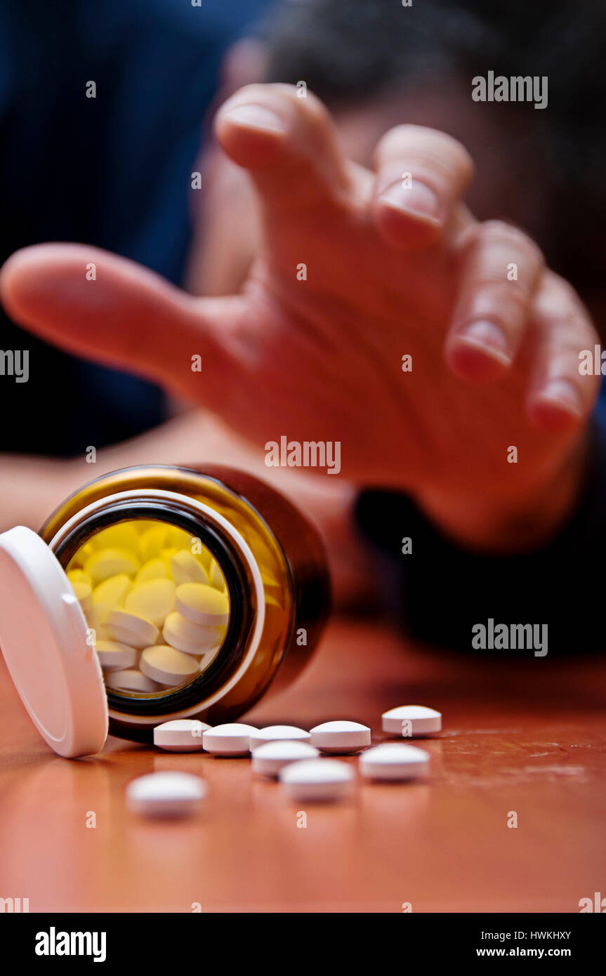 man desperately reaching for drugs Stock Photo - Alamy