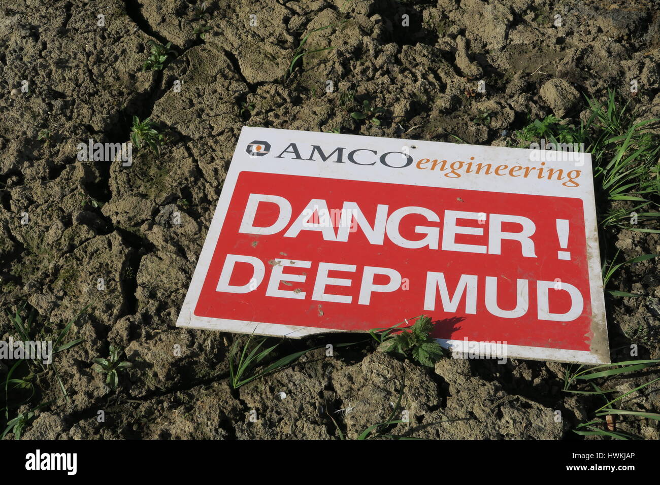 Warning sign - deep mud after dredging of river Stock Photo - Alamy