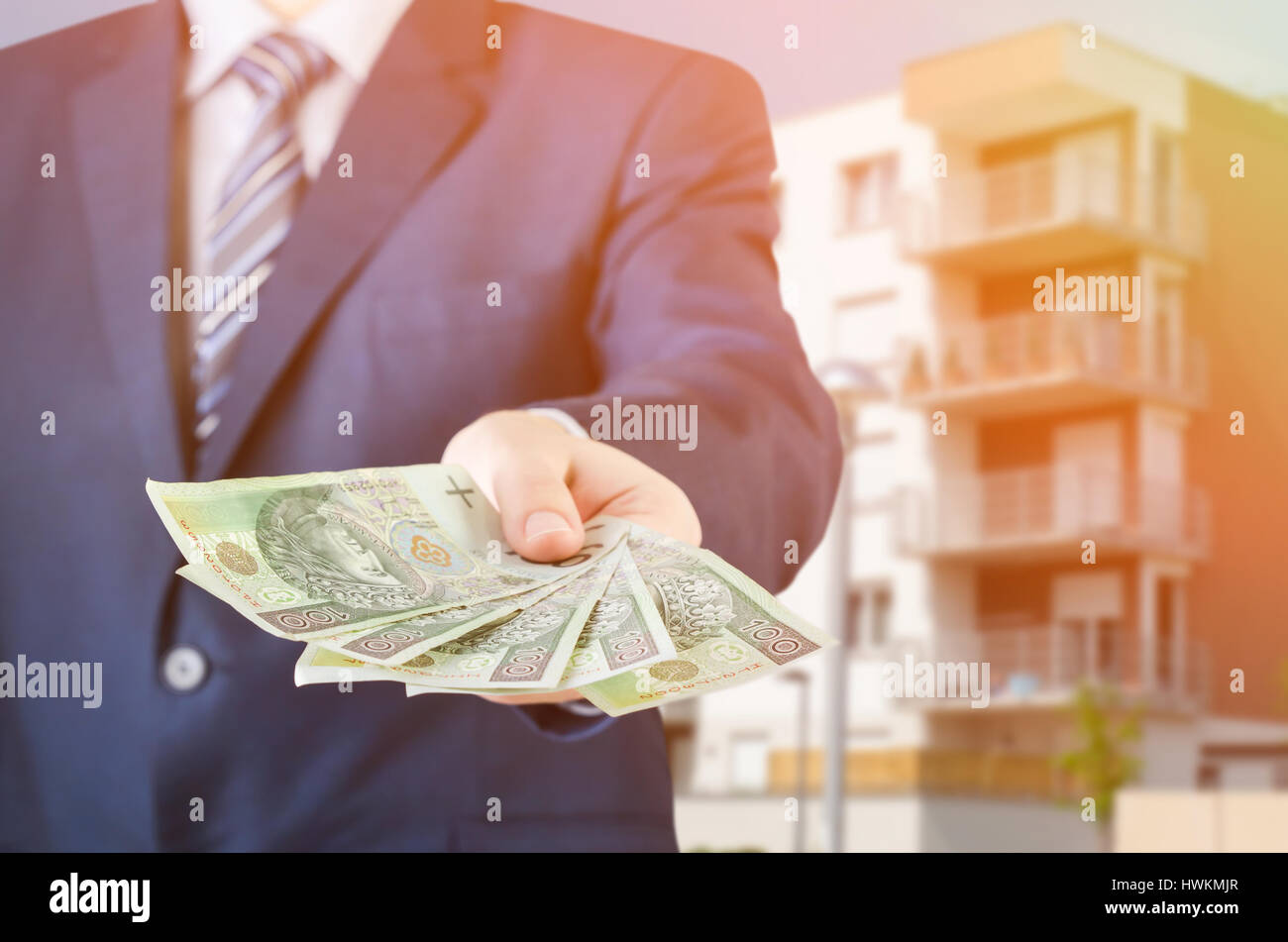 Polish businessman holds money. The loan on the house. Money loan ...