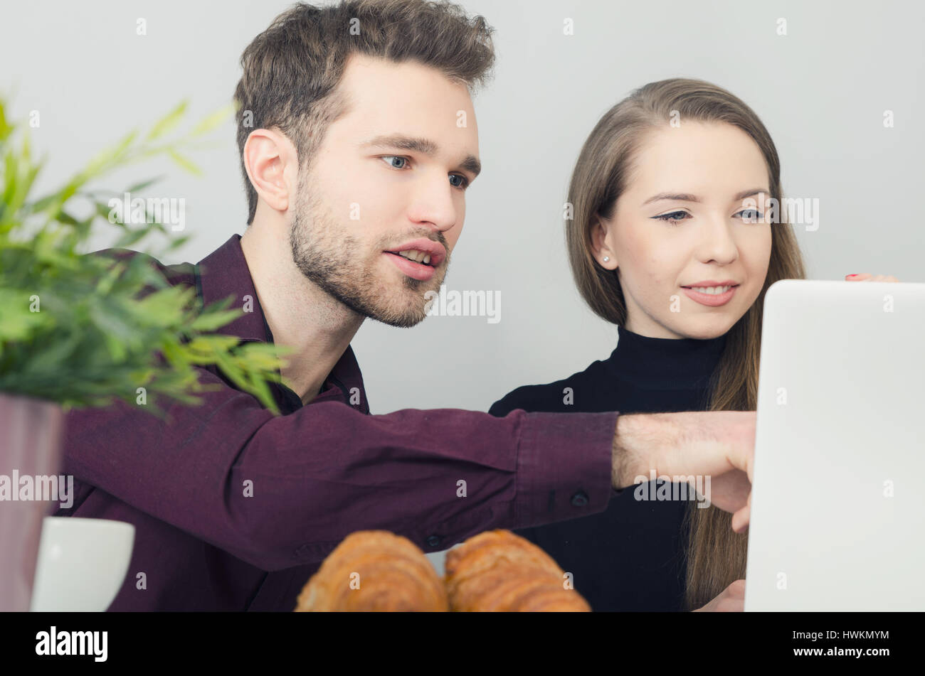 Couple cooperates with the computer in the office. laptop working ...