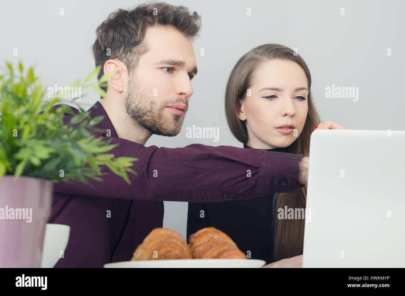 Couple cooperates with the computer in the office. laptop working ...