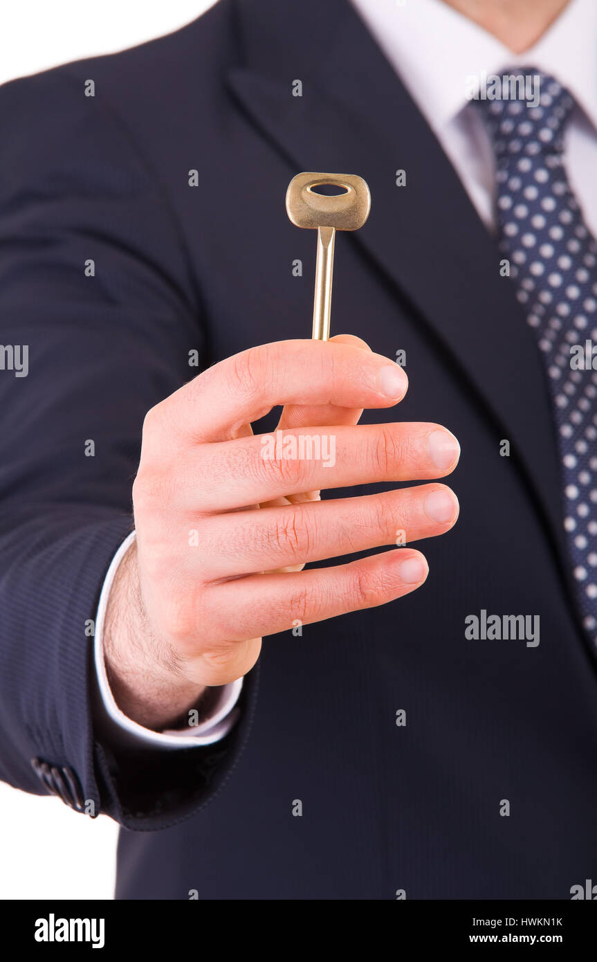 Businessman holding key Stock Photo - Alamy