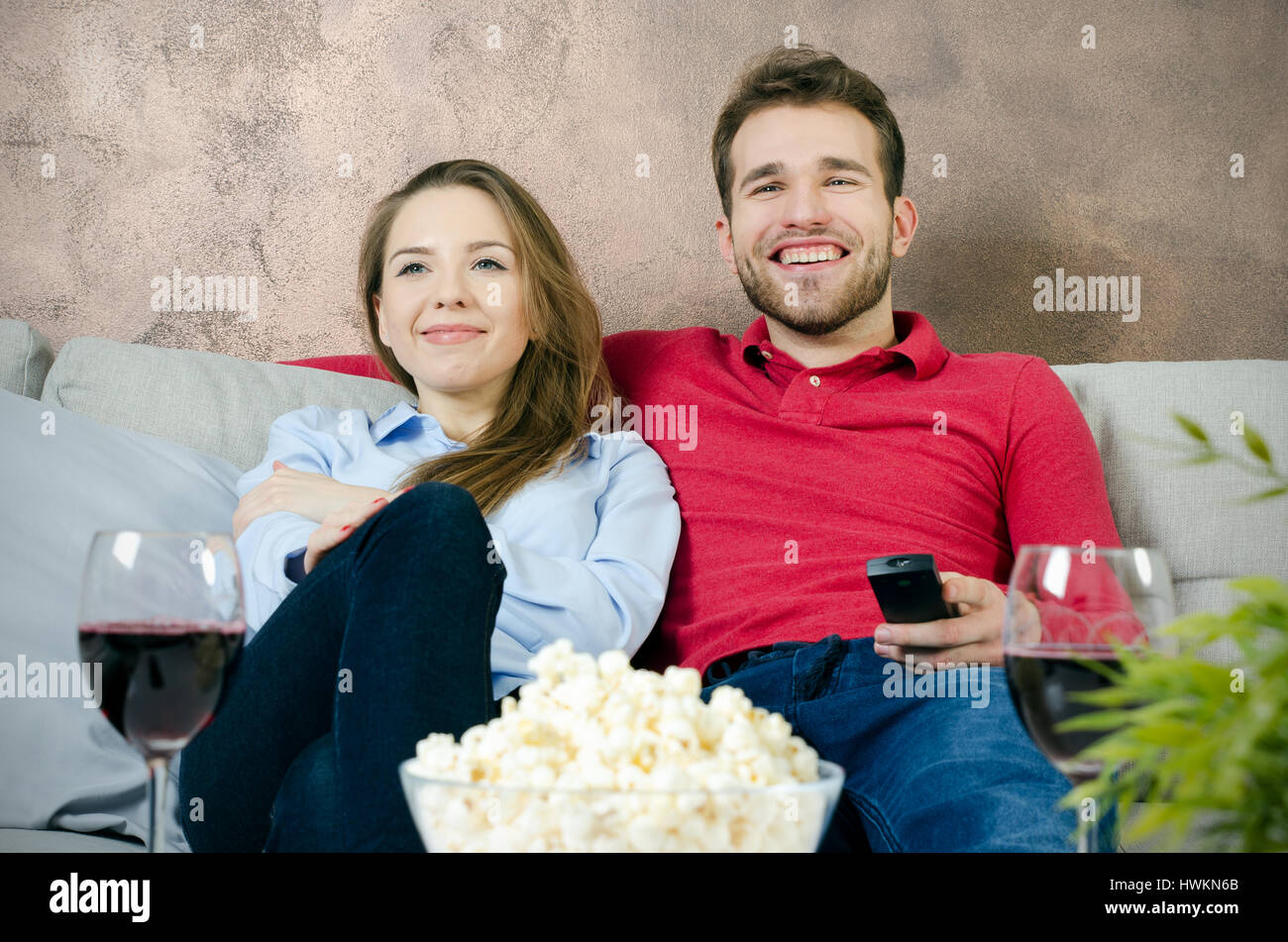 Couple enjoys free time and watching tv. couple watching movie home fun ...