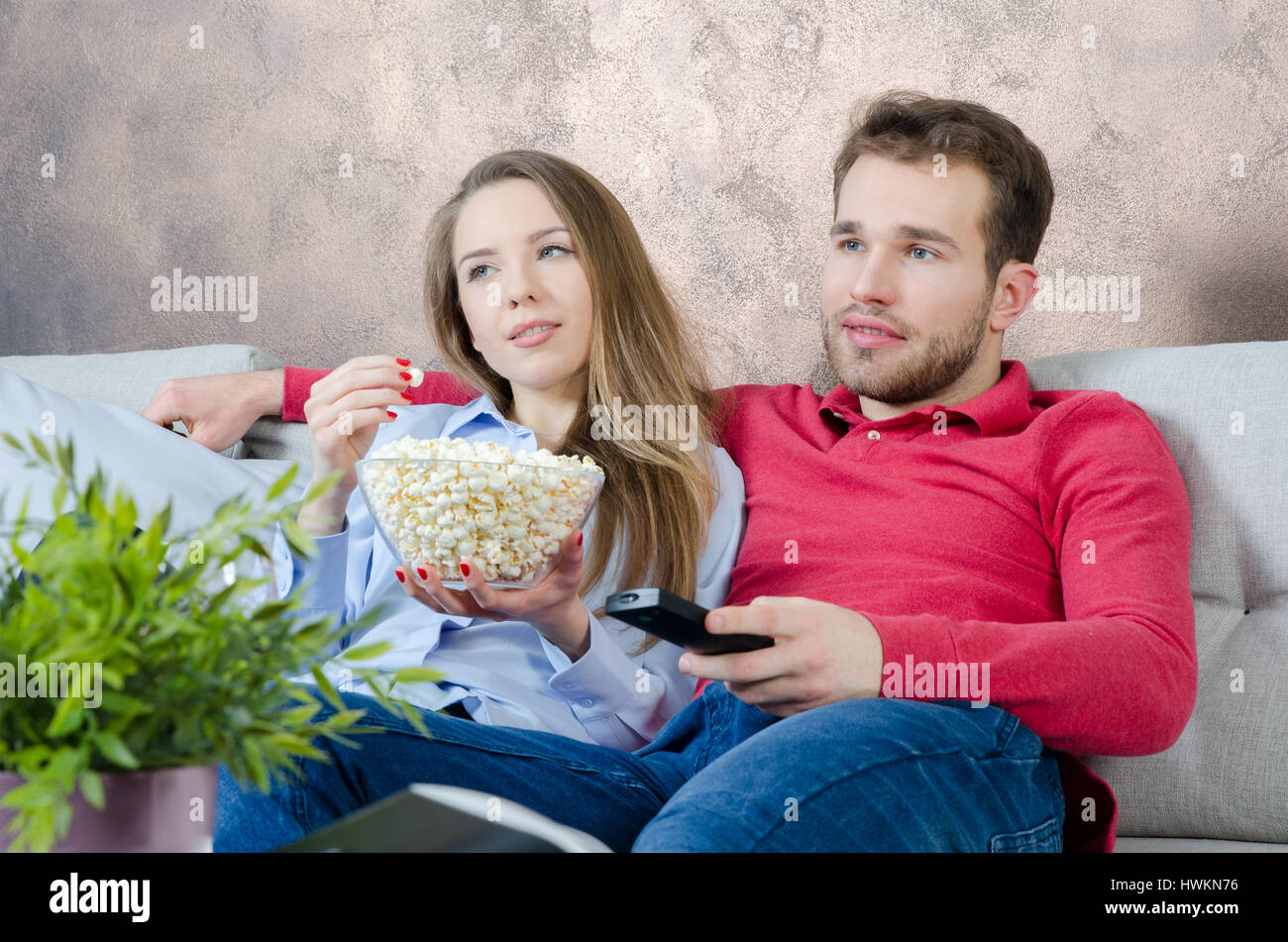 Couple enjoys free time and watching tv. couple watching movie home fun ...