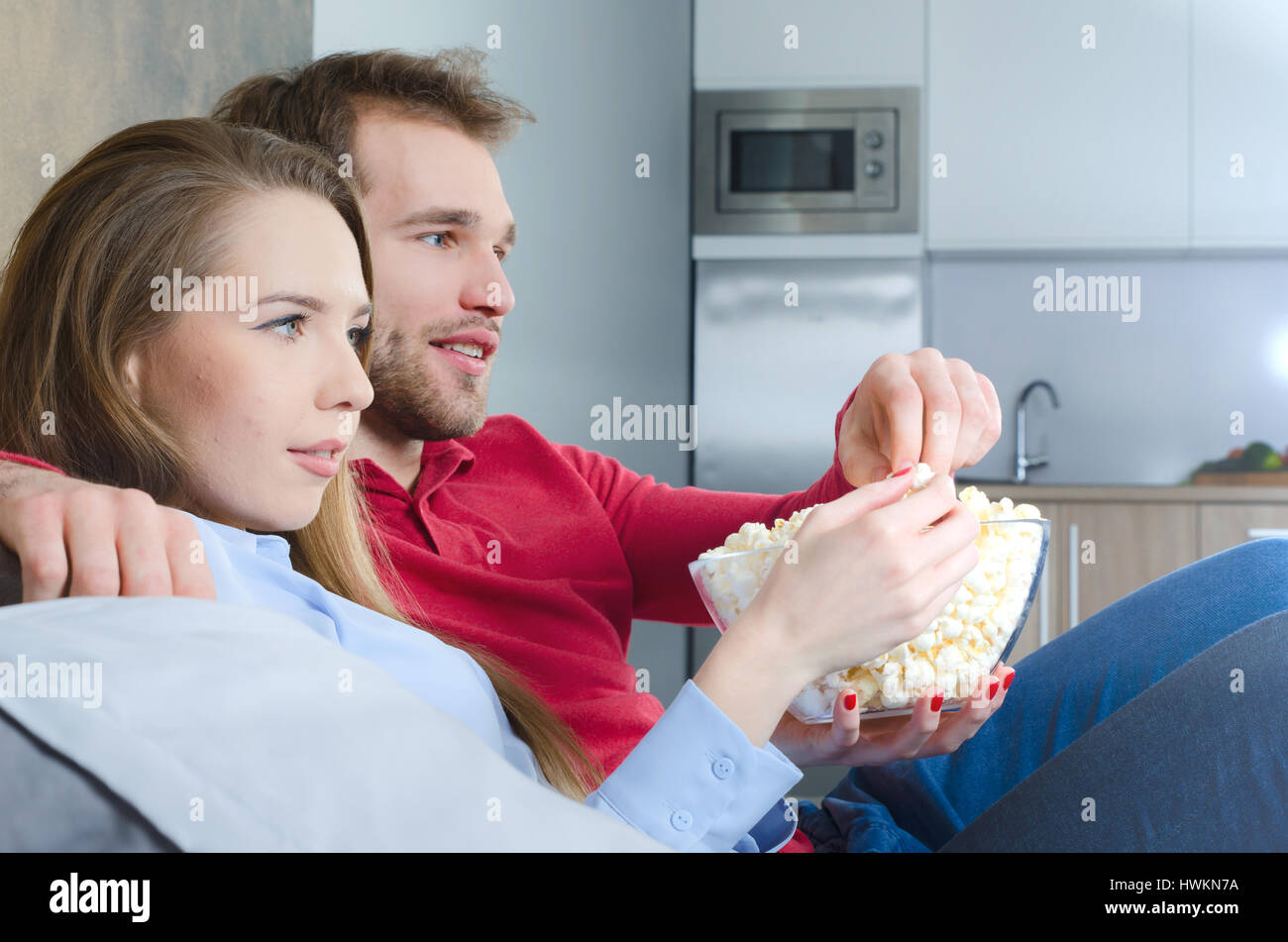 Couple enjoys free time and watching tv. couple watching movie home fun ...