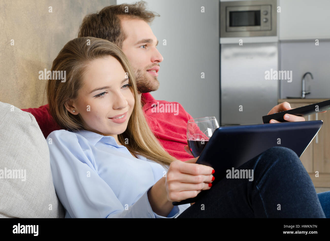 Couple enjoys free time and watching tv. couple watching movie home fun ...