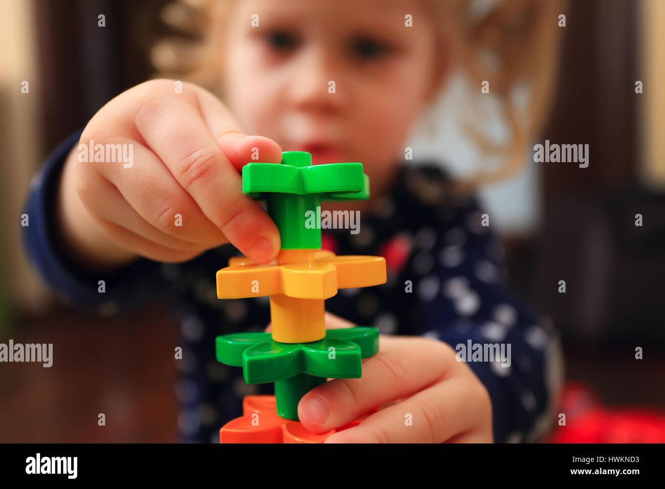 Child trying build tower with constructor close-up. Closeup of colorful ...