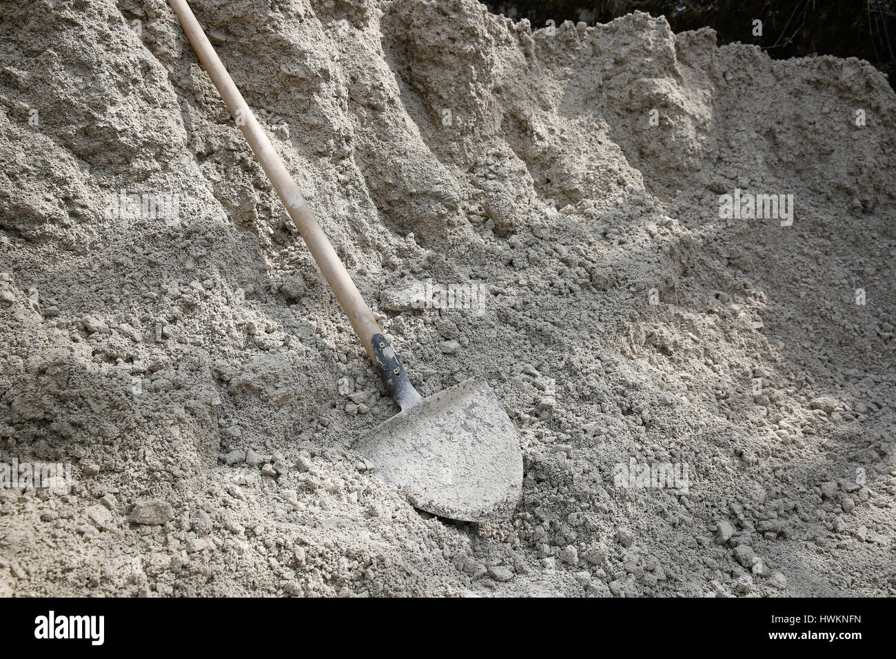 Shovel lying on a pile of construction sand and gravel for concrete ...