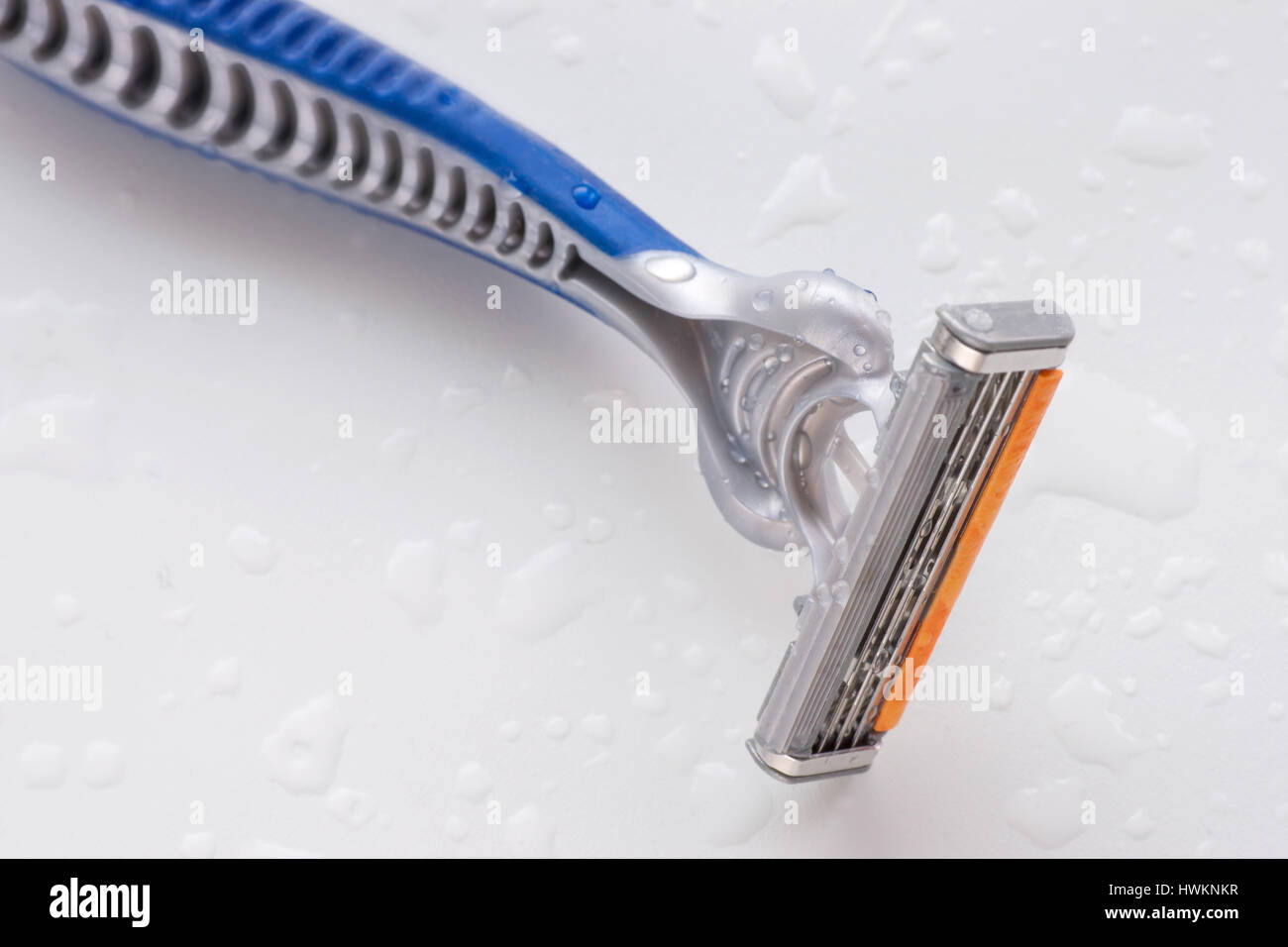 Disposable razor blade close up on white wet background with water ...