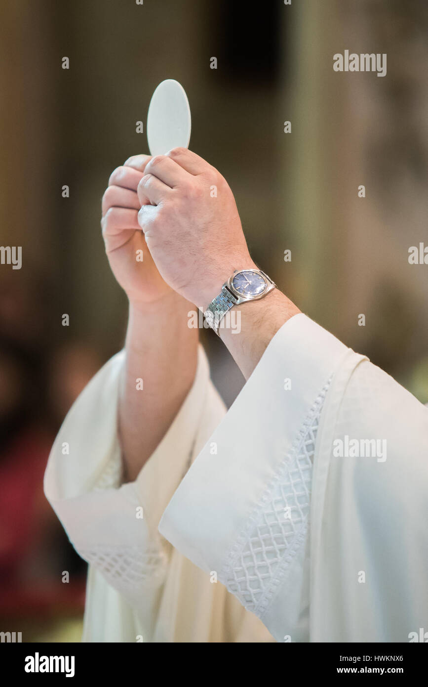 The holy bread of the communion during the mass Stock Photo - Alamy