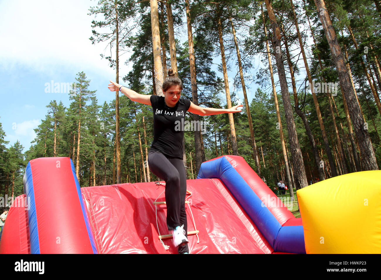 Jumping on the inflatable slides. Children's attraction Stock Photo - Alamy