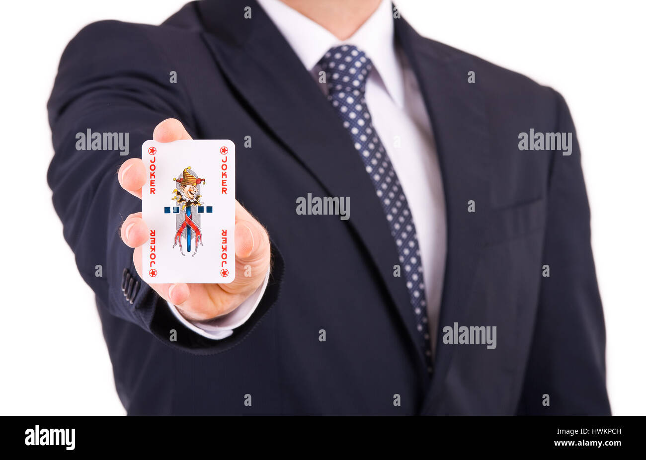Businessman showing playing card Stock Photo - Alamy