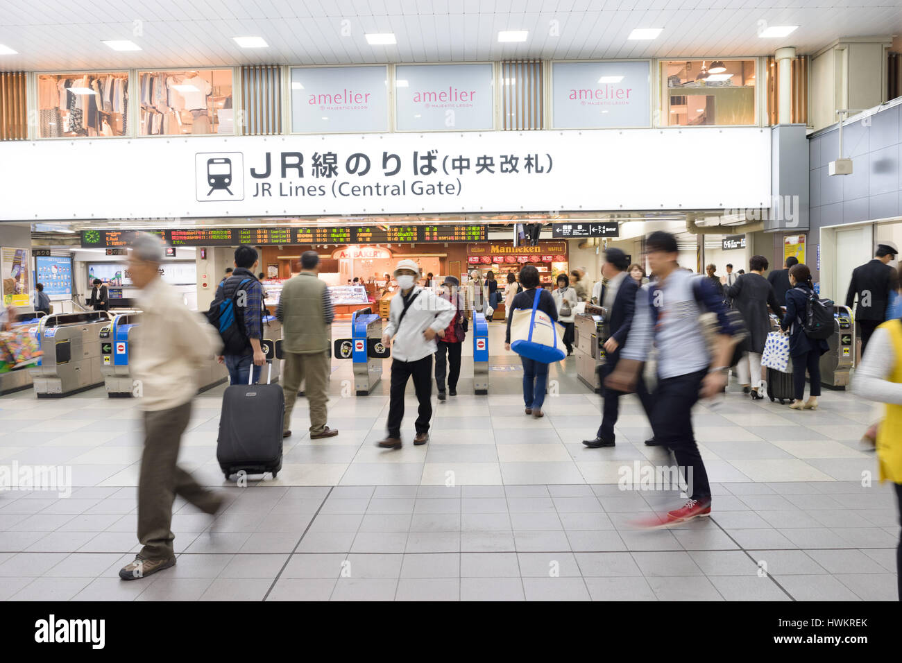 OSAKA, JAPAN CIRCA APRIL 2016:People passes the gate. Commuter trains ...
