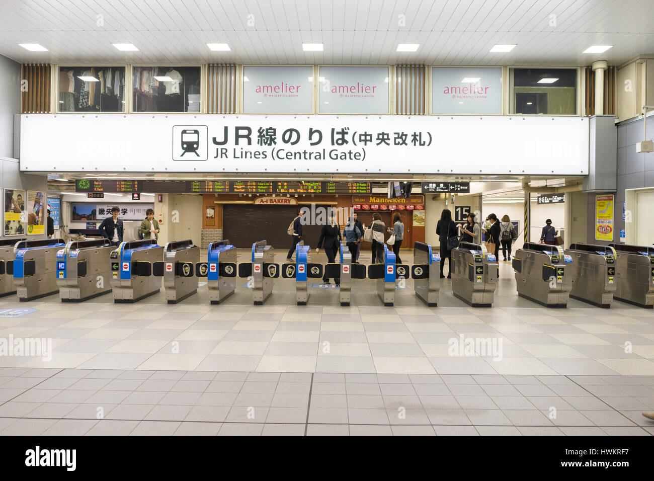 OSAKA, JAPAN CIRCA APRIL 2016:People passes the gate. Commuter trains ...