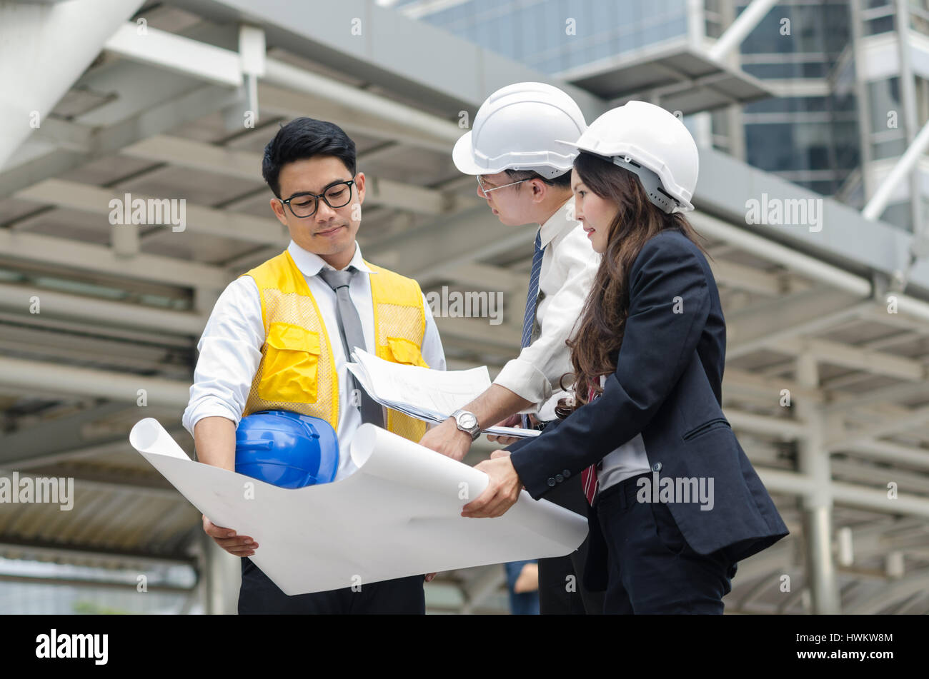 Group of Architects team discussing about new project with paperwork ...