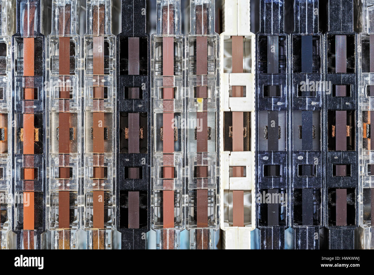 Old and dusty Compact Cassettes arranged vertically in a row form the ...