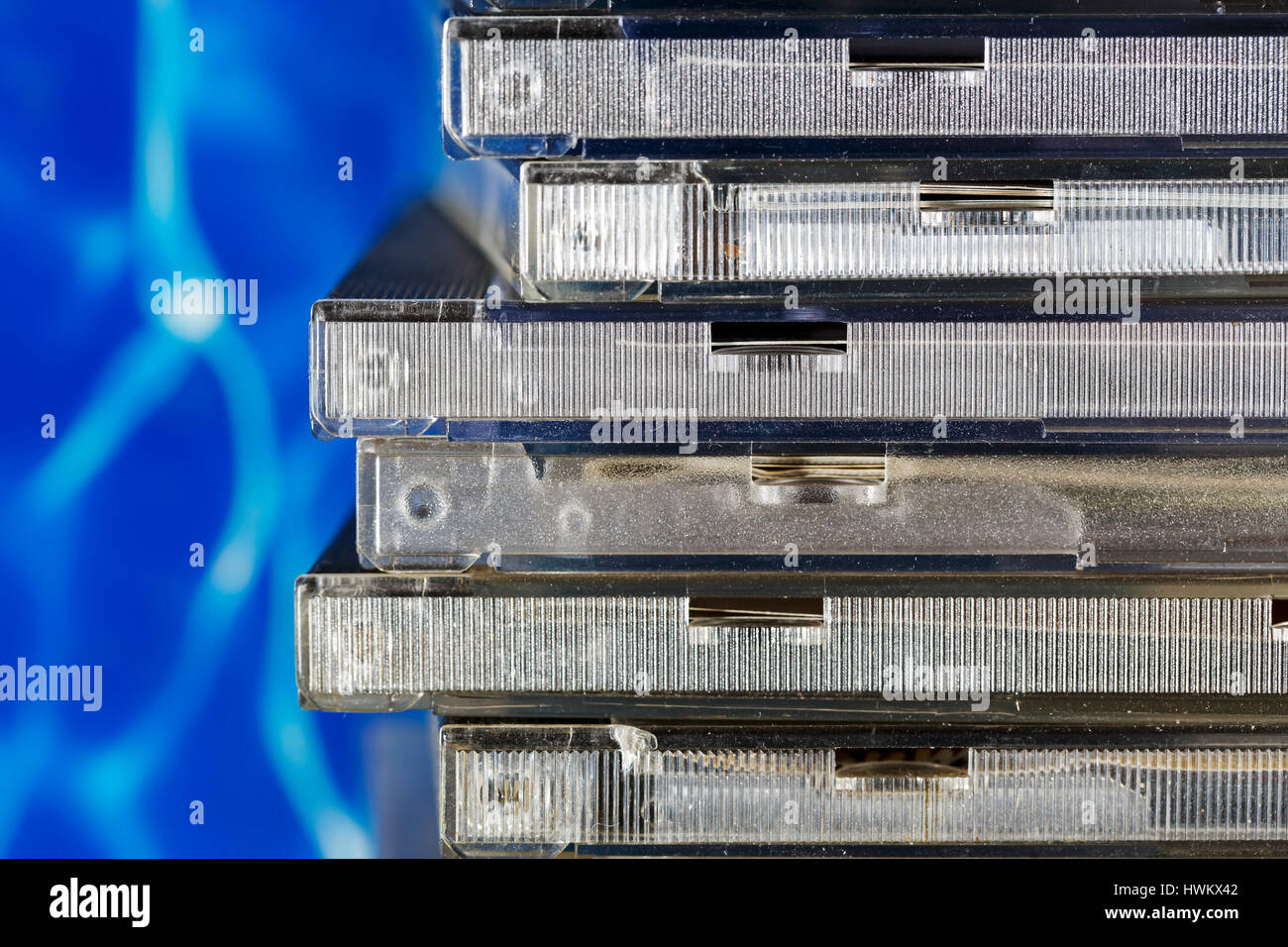 The stack of used CD boxes is shown against a blue background Stock ...