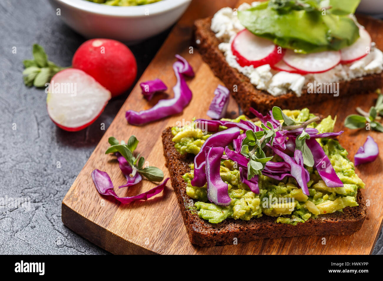 Toasts with cream cheese, radish and avocado and with avocado and red ...