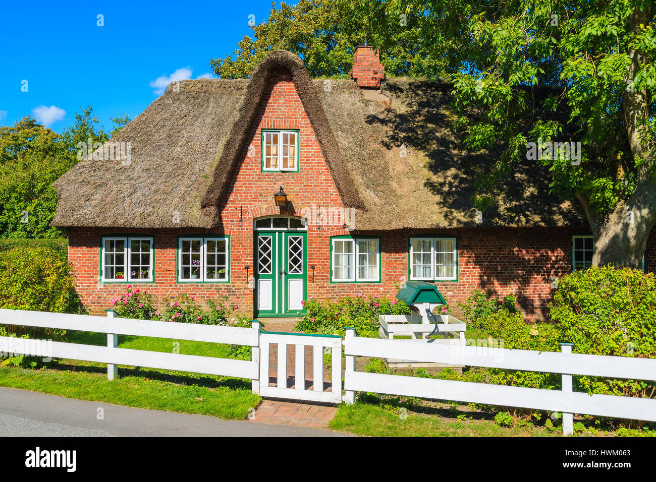 Typical red brick Frisian house with straw roof in Keitum village on ...