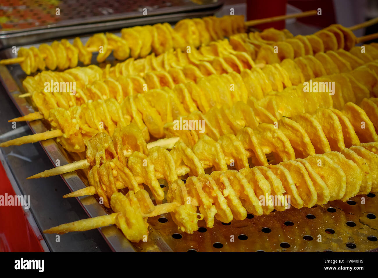 CHONGYUANG TEMPLE, CHINA: Delicious curly potato fries being prepared ...