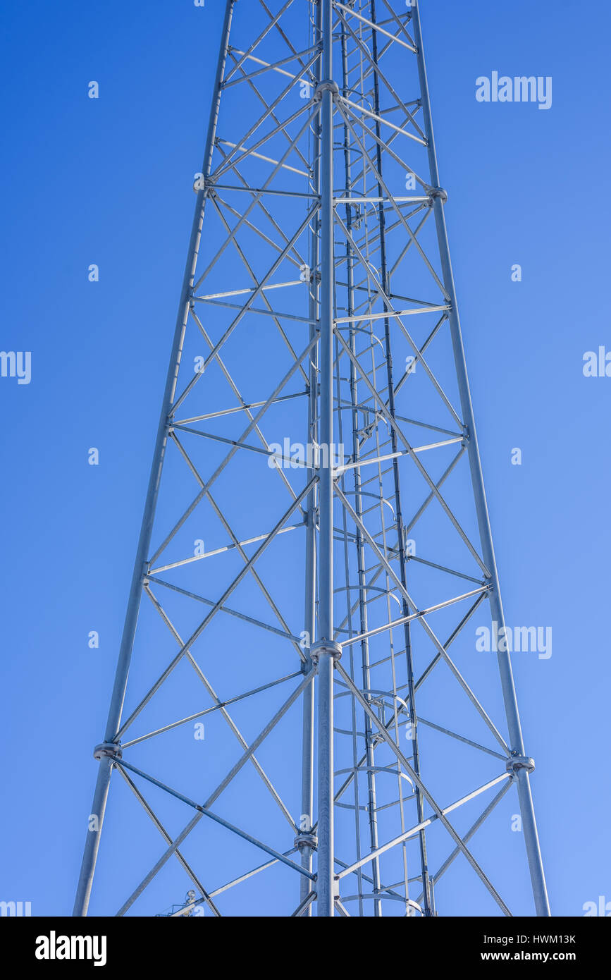 Steel tower with ladder inside against a blue sky Stock Photo - Alamy