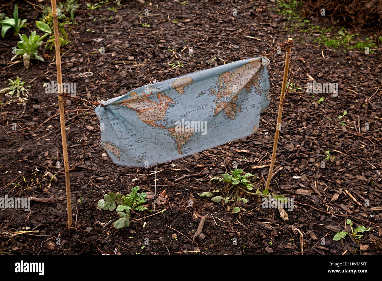 A map of the world tied to two bamboo canes in a 'secret garden' in ...