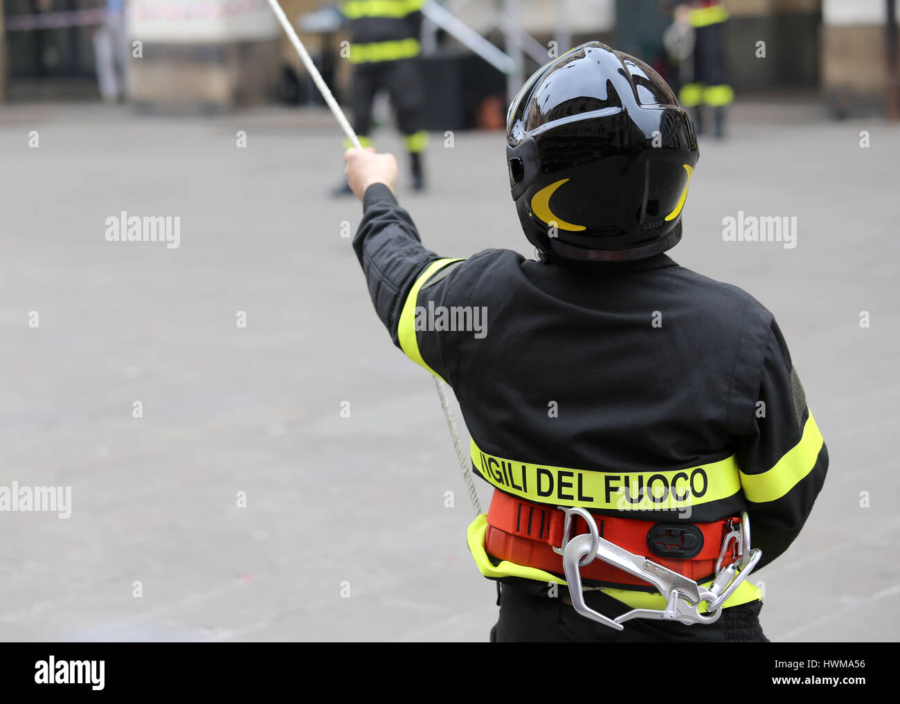 Italian firefighter with protective helmet and a long rope and the word ...