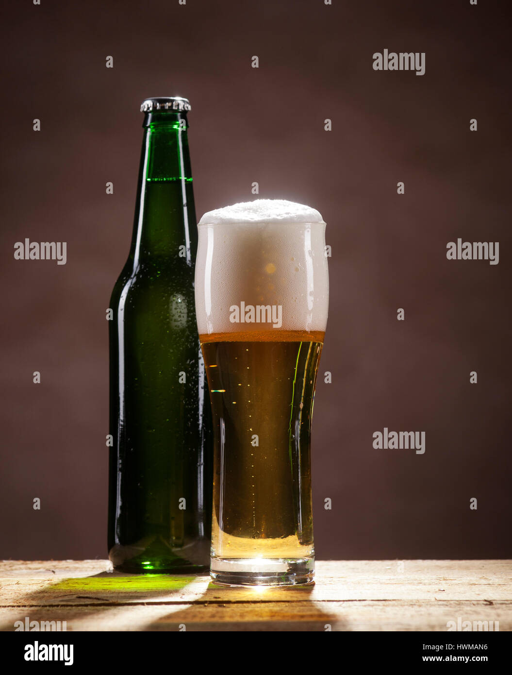 Beer mug and buttle on a brown dark background Stock Photo - Alamy