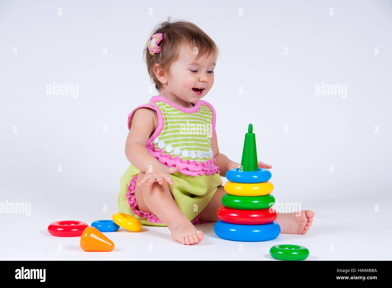 Cute little girl playing with a toy pyramid Stock Photo - Alamy