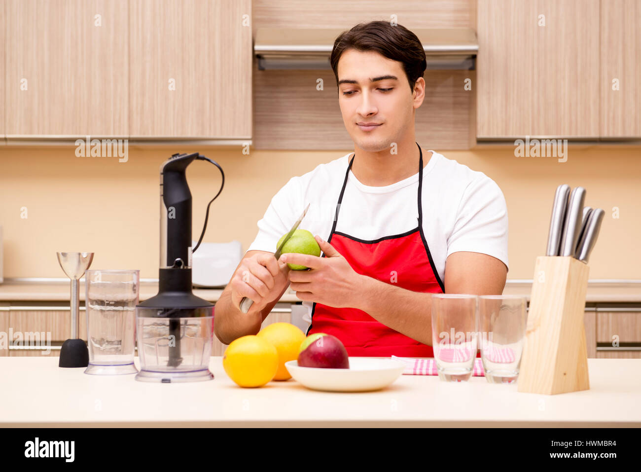 Handsome man working at the kitchen Stock Photo - Alamy