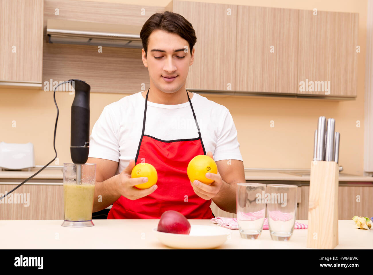 Handsome man working at the kitchen Stock Photo - Alamy