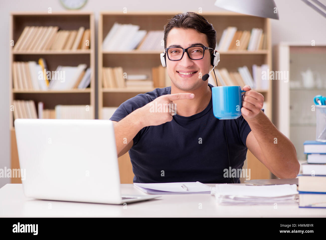 Young student drinking coffee from cup Stock Photo - Alamy
