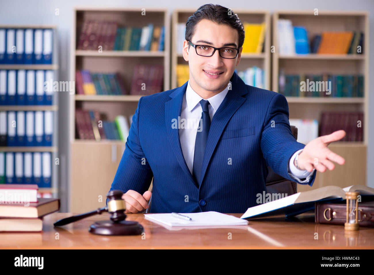 Handsome judge with gavel sitting in courtroom Stock Photo - Alamy